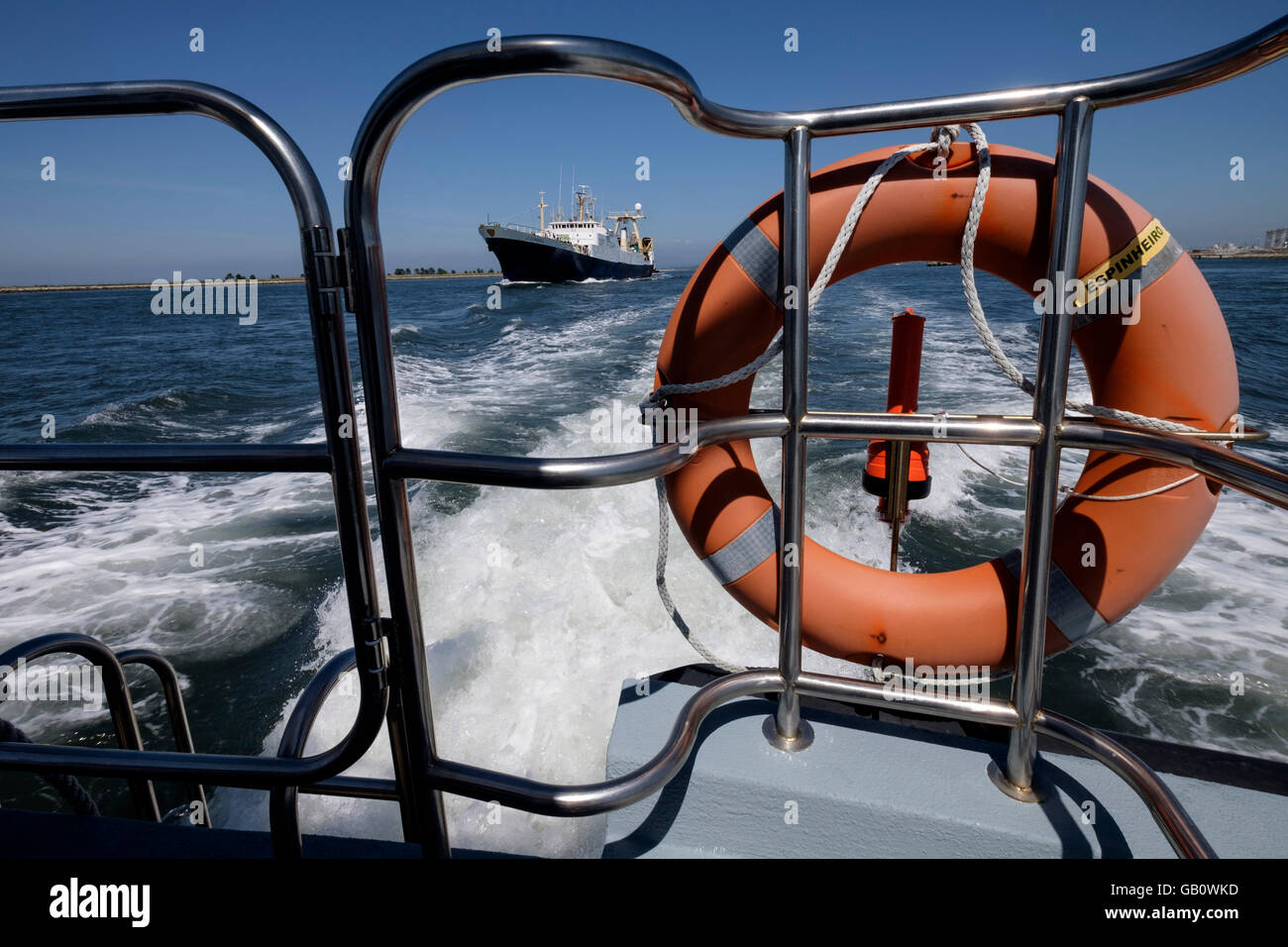 Orange life saver ring on the railing of a ship Stock Photo - Alamy