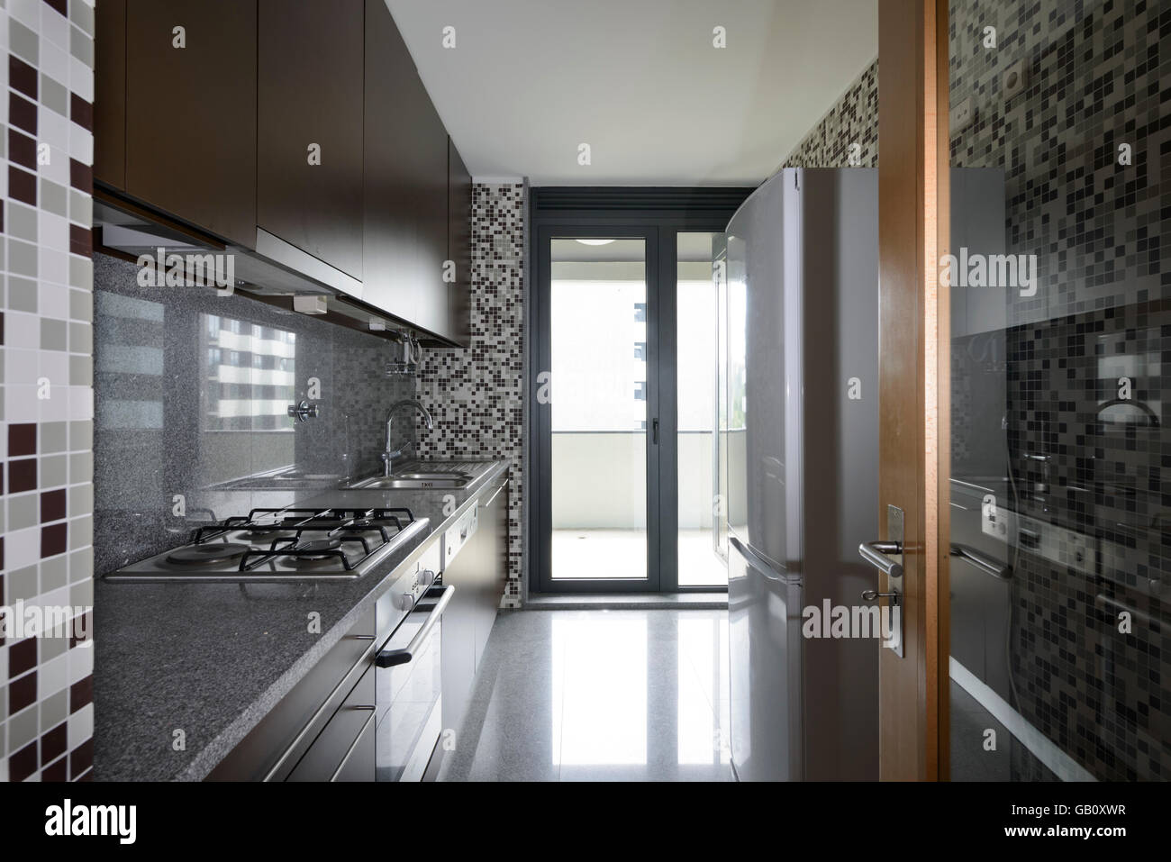 Narrow kitchen with modern design Stock Photo - Alamy