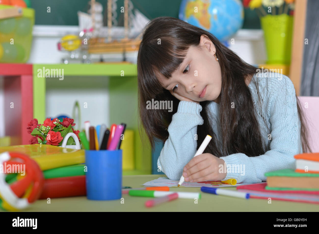 Little girl drawing at class Stock Photo - Alamy