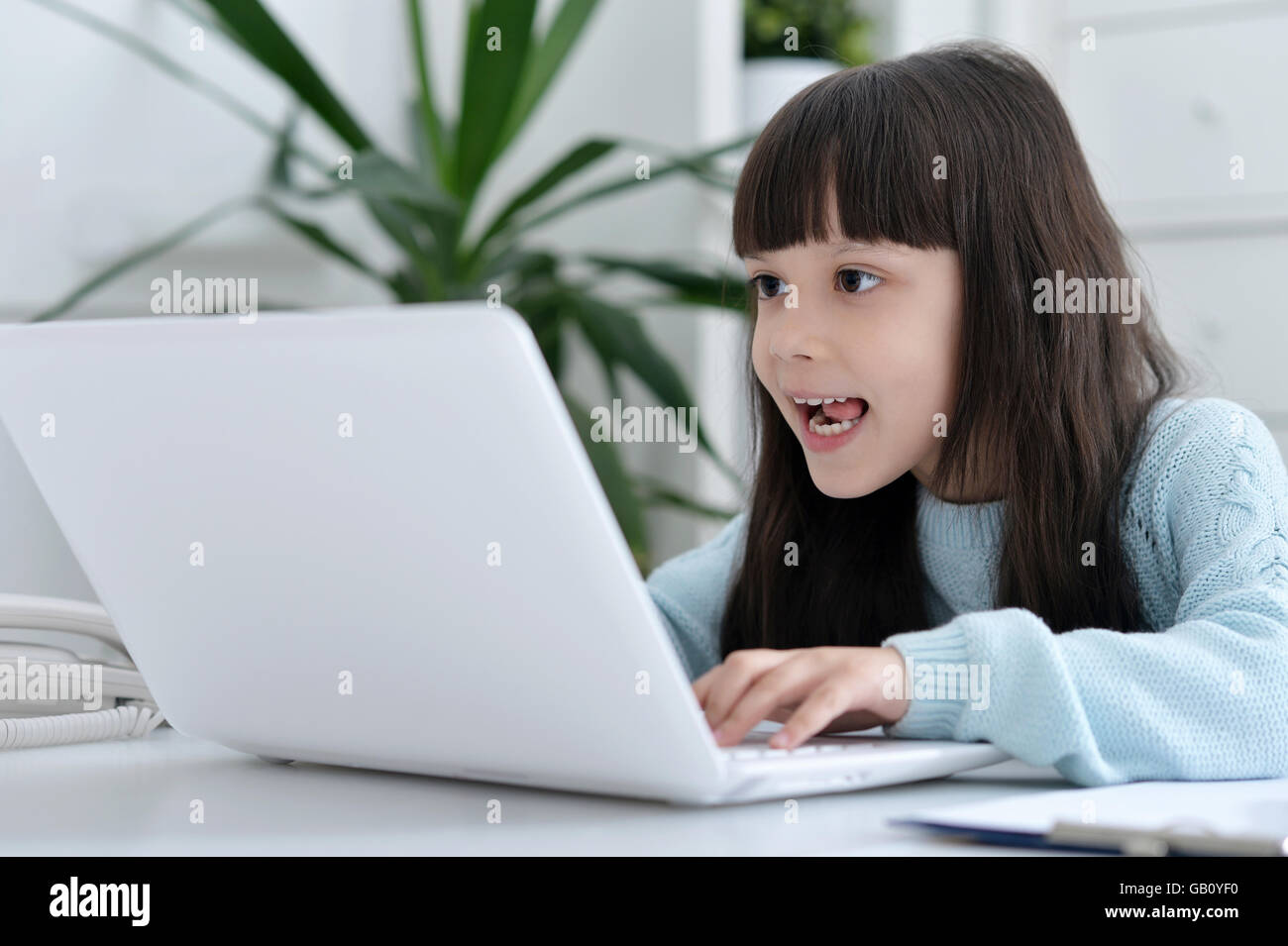 Little girl using computer Stock Photo - Alamy