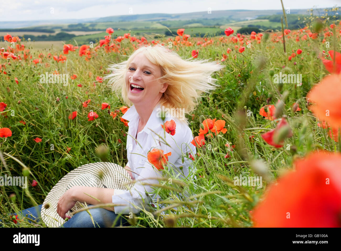 Beautiful woman amongst poppy fields near Ditchling Beacon Sussex South ...
