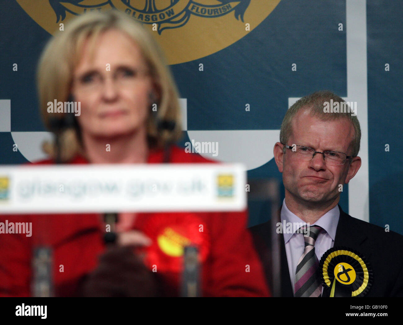 SNP candidate John Mason looks on as Labour candidate Margaret Curran ...