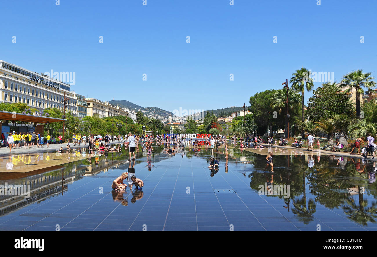 People have fun in fountain near the big UEFA EURO 2016 logo at ...