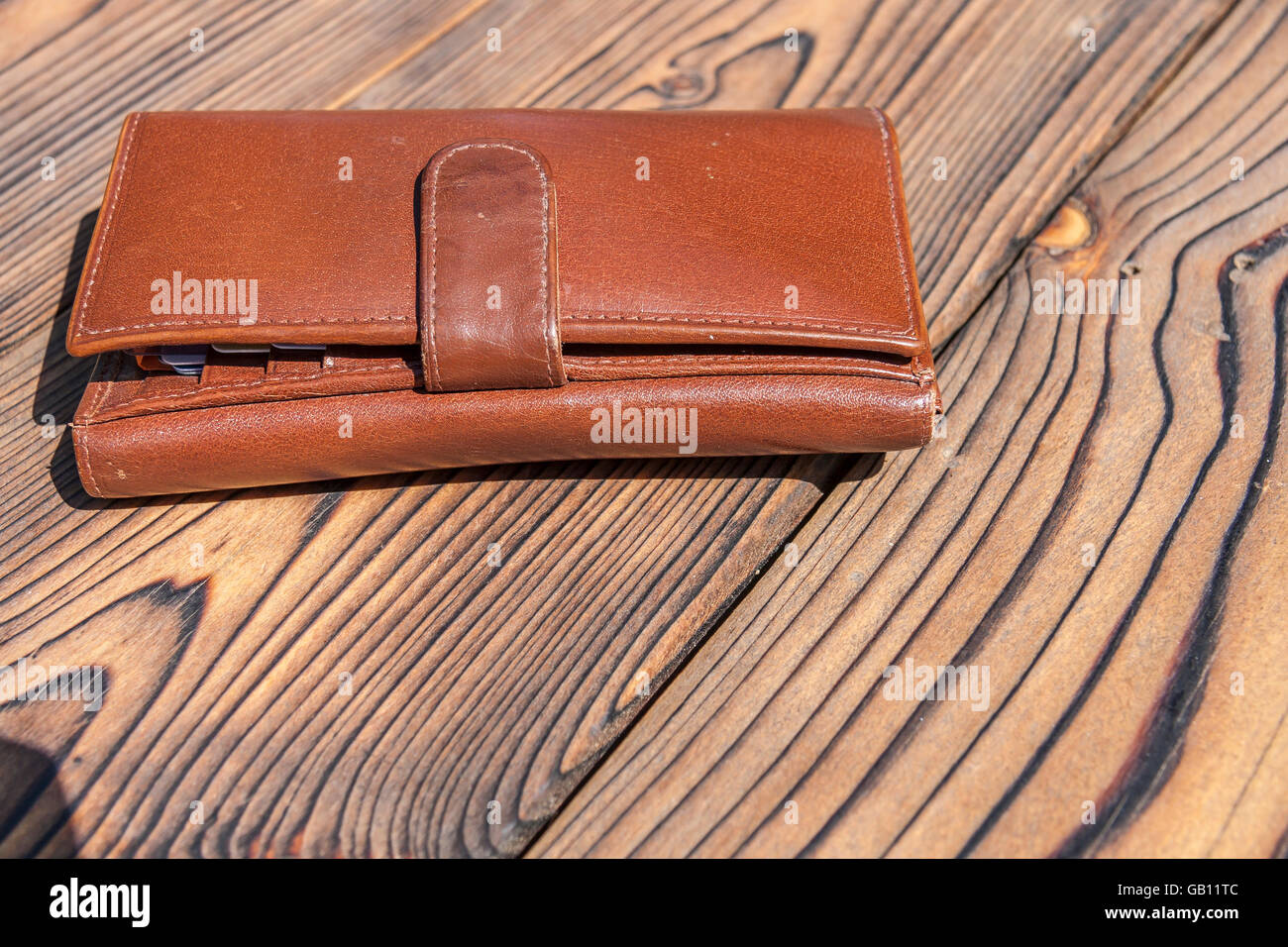 Old wallet on wooden table Stock Photo - Alamy