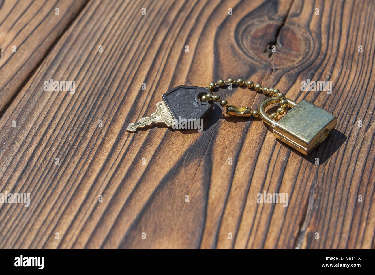 Padlock And Key on wood table Stock Photo - Alamy