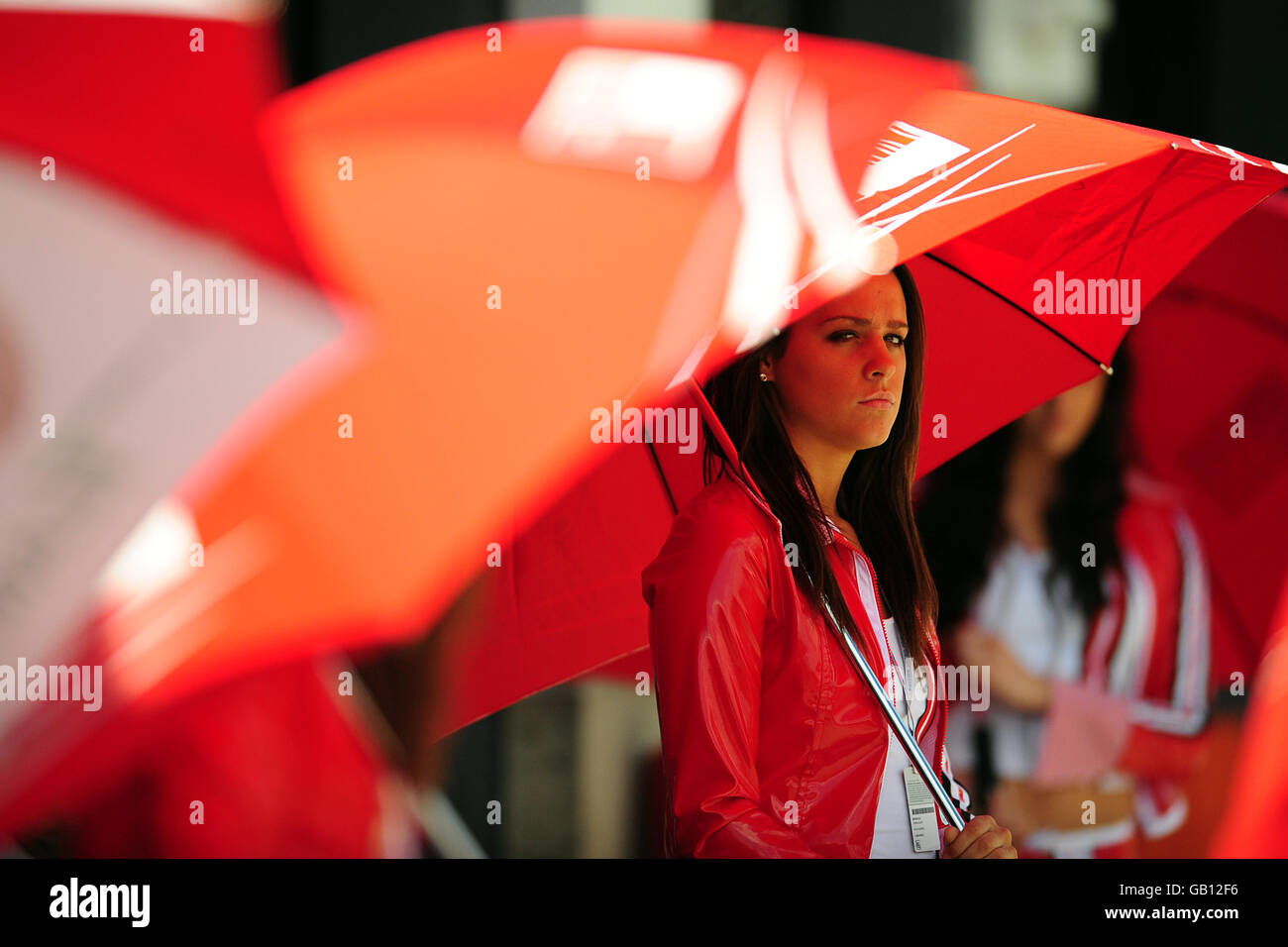 A Ducati girl takes shade from the sun, in the pits before practice for ...