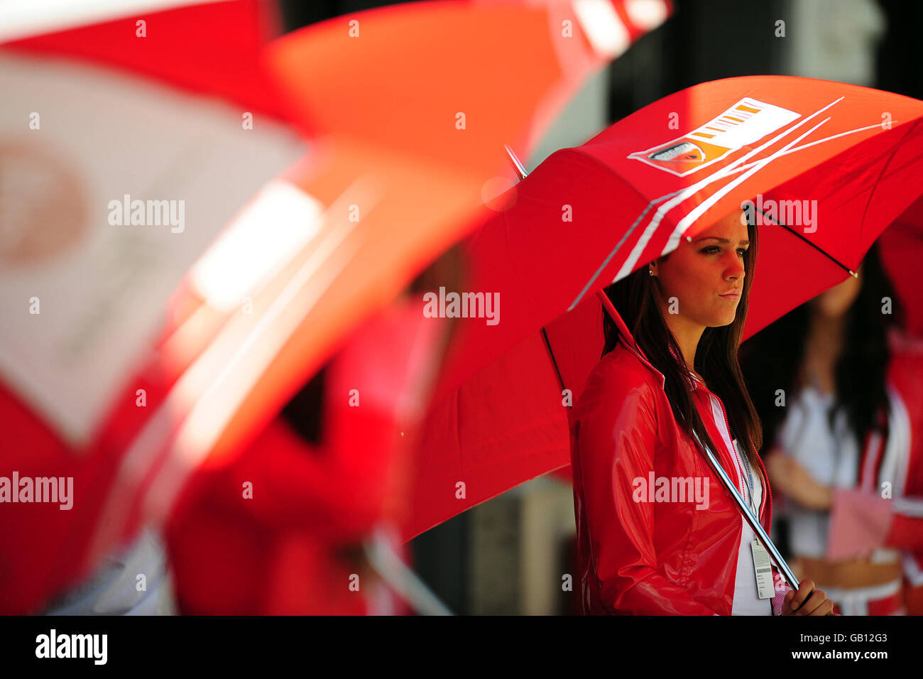 A Ducati girl takes shade from the sun, in the pits before practice for ...