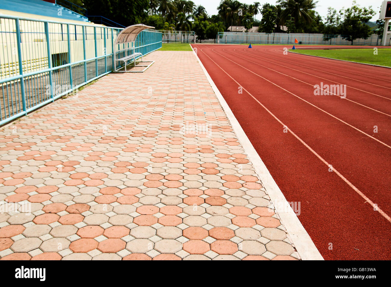 Red running track in stadium Stock Photo - Alamy