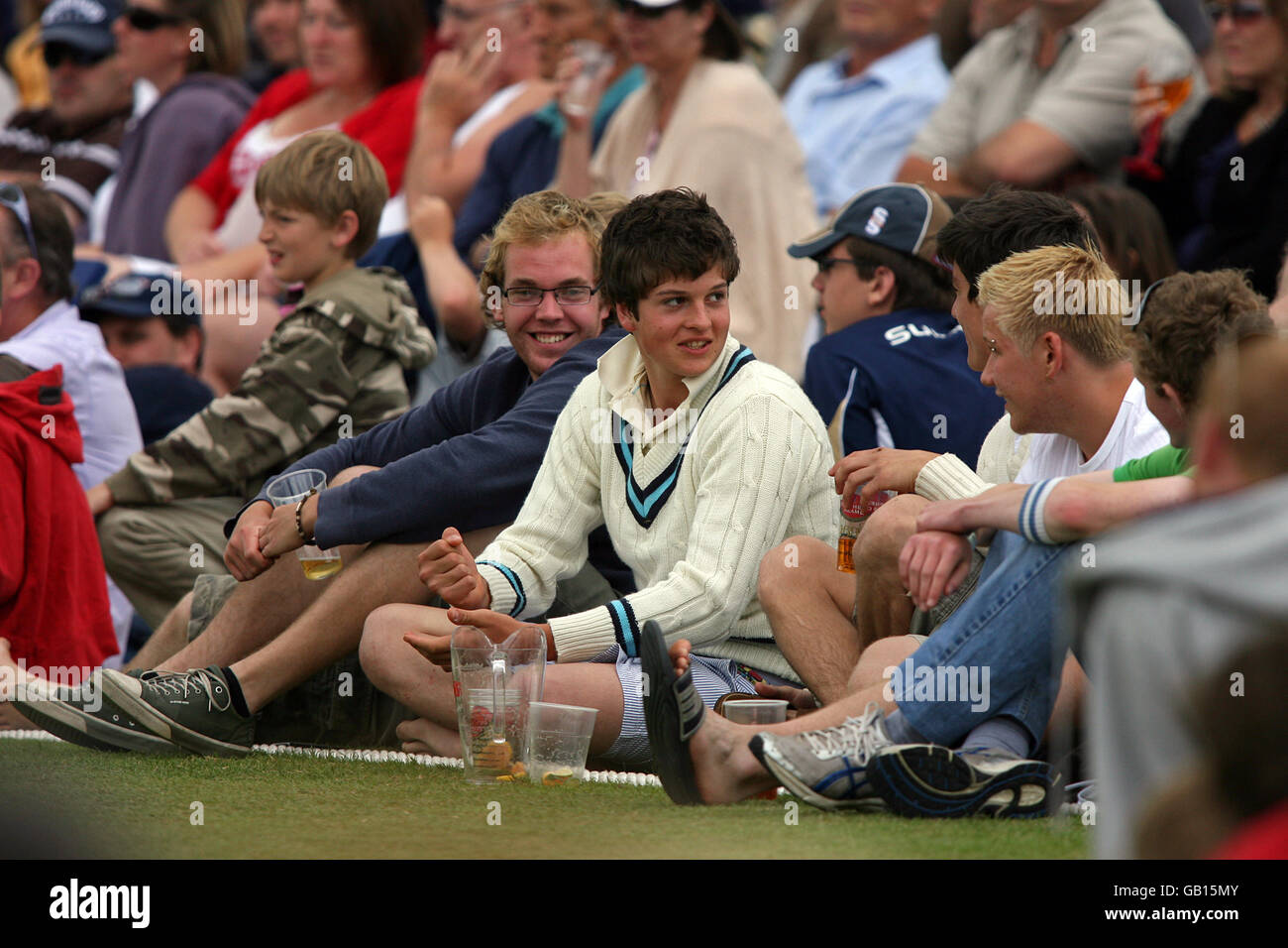 Fans and spectators enjoy the game from behind the boundary rope, at ...