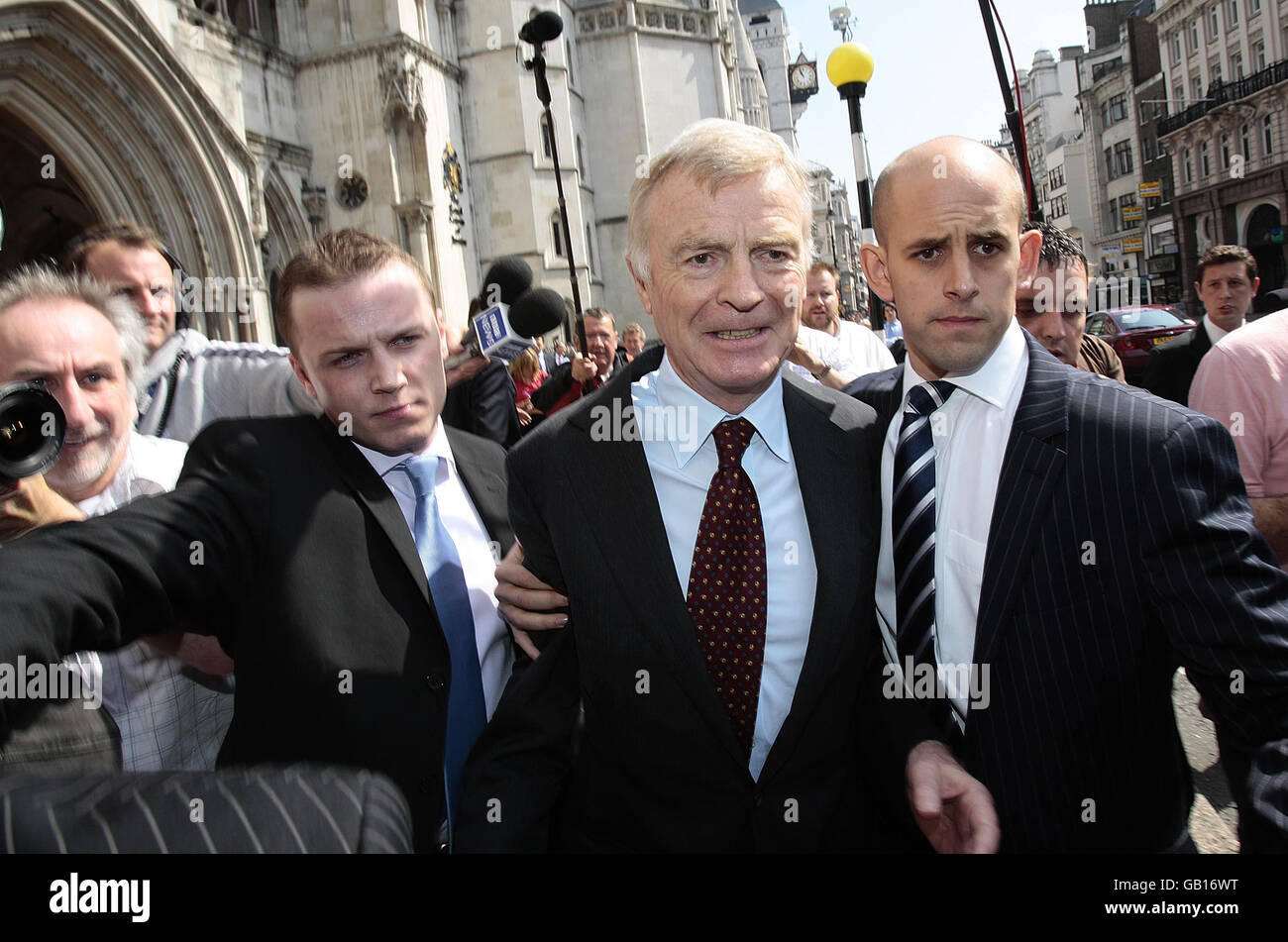 FIA President Max Mosley (centre) leaves the High Court in London, on ...