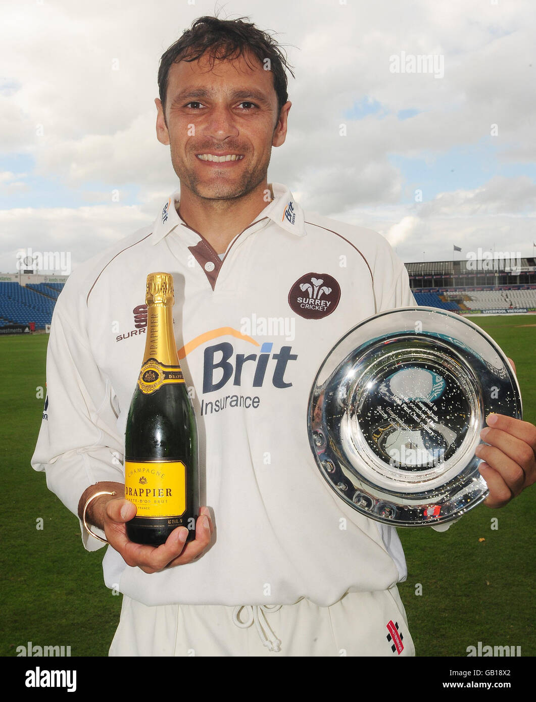 Surrey's Mark Ramprakash with a silver plate and bottle of champagne ...