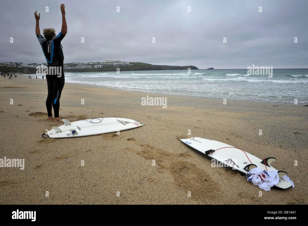 Surfer stretches arms on beach hi-res stock photography and images - Alamy