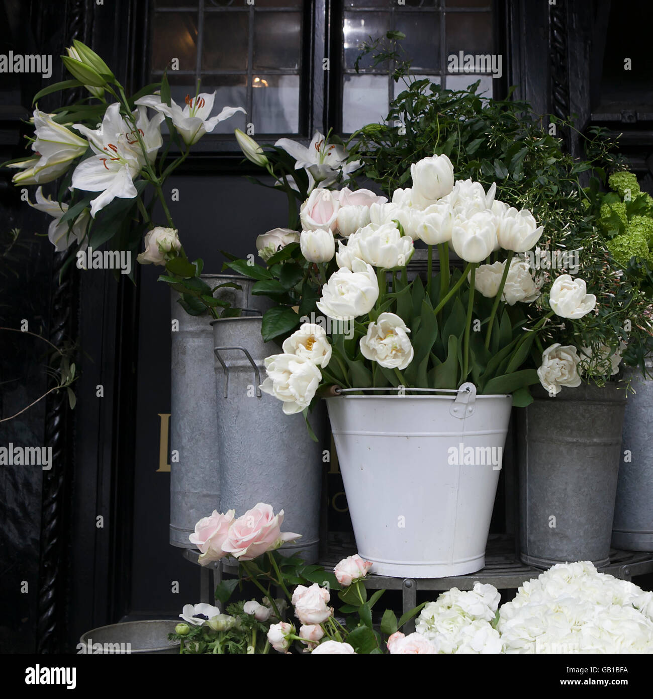 white tulips, lilies and roses in a bucket for sale Stock Photo - Alamy