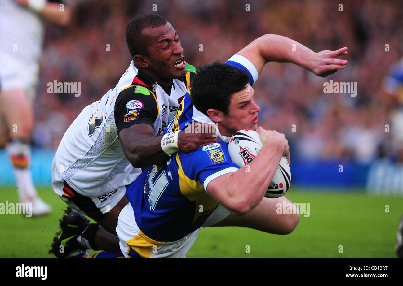 Leeds Rhinos' Luke Burgess goes over to score a try under pressure from ...