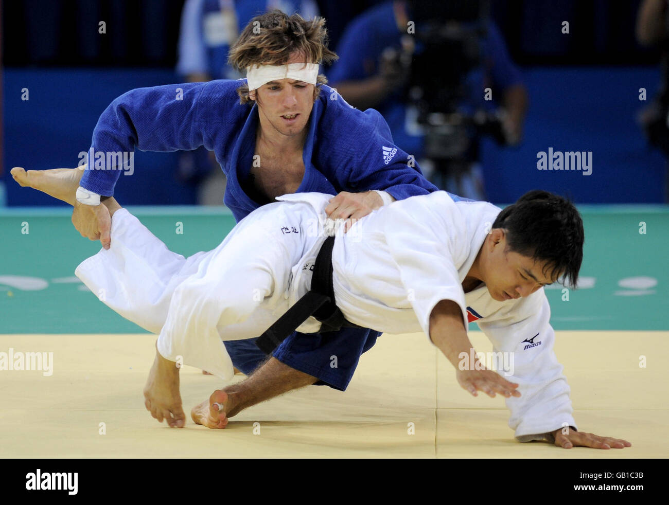 Great Britain's Craig Fallon (blue) in action against North Korea's ...