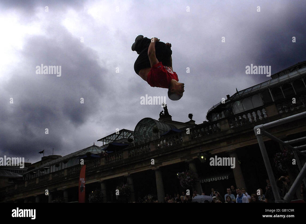 A free runner performs a backflip in Covent Garden, London, as part of ...