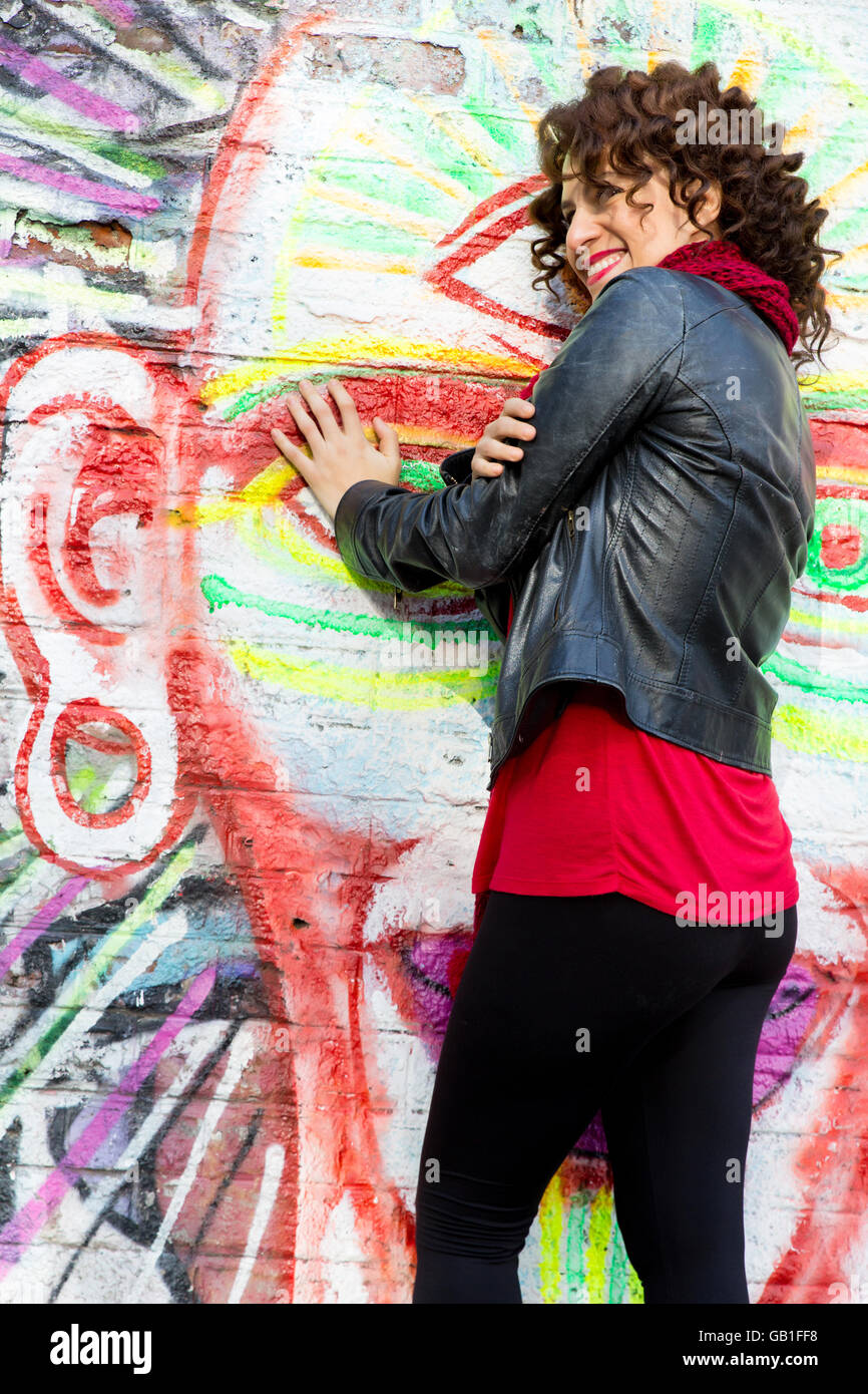 Gorgeous brunette woman posing with spiritual graffiti head on the ...