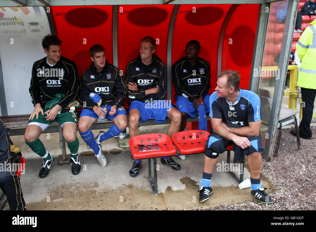 Portsmouth new signing Peter Crouch takes his place on the bench before ...