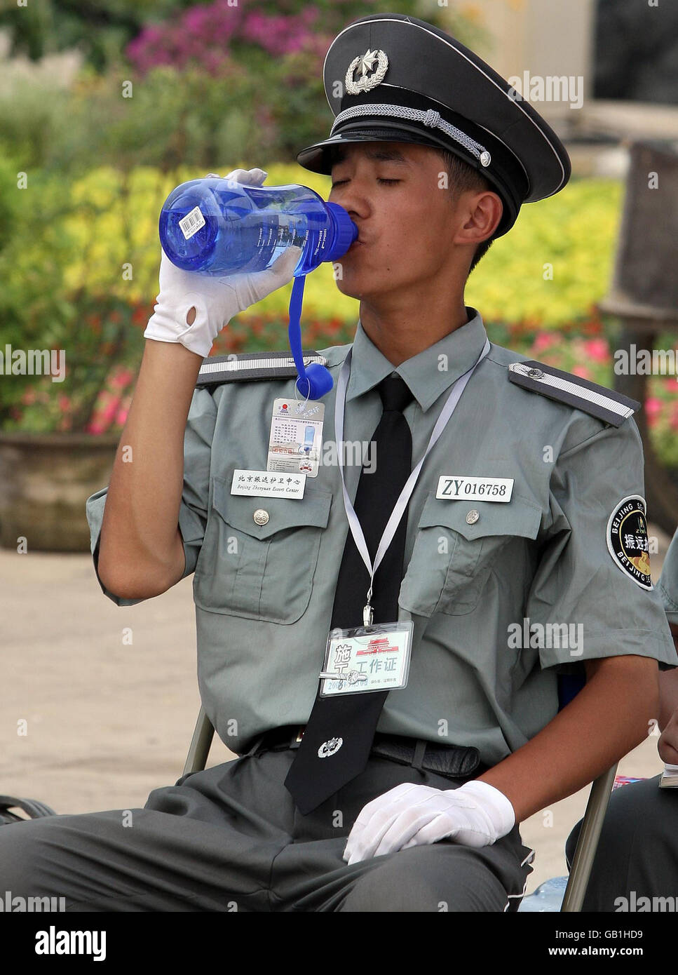 Olympics - Beijing Olympic Games 2008. A security guard takes a drink ...
