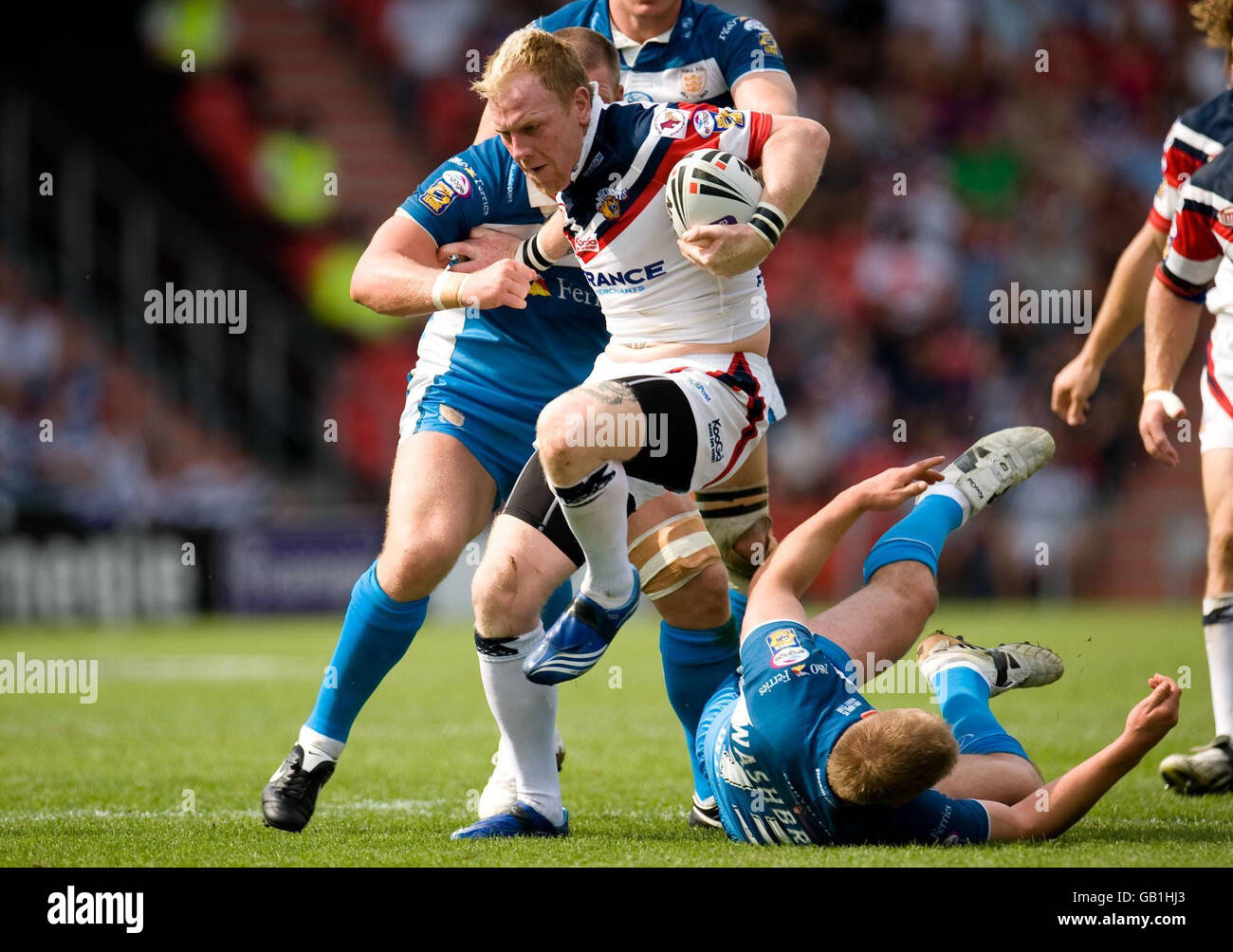Wakefield's Paul Reilly breaks the tackles of Hull FC's Danny Tickle ...