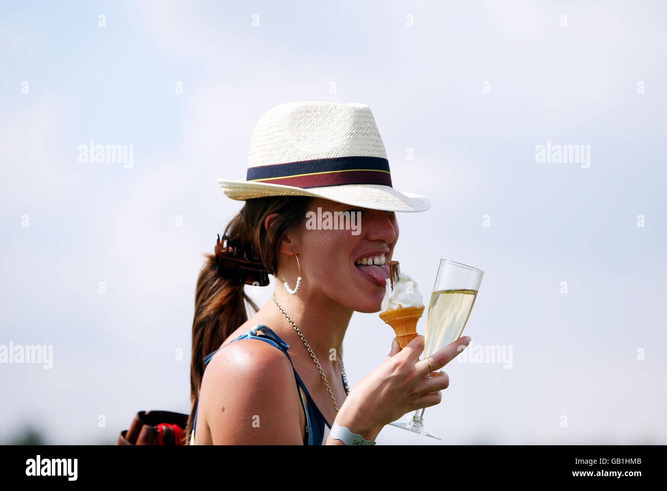 A Polo fan enjoys an icecream and a glass of champagne at the Cartier ...
