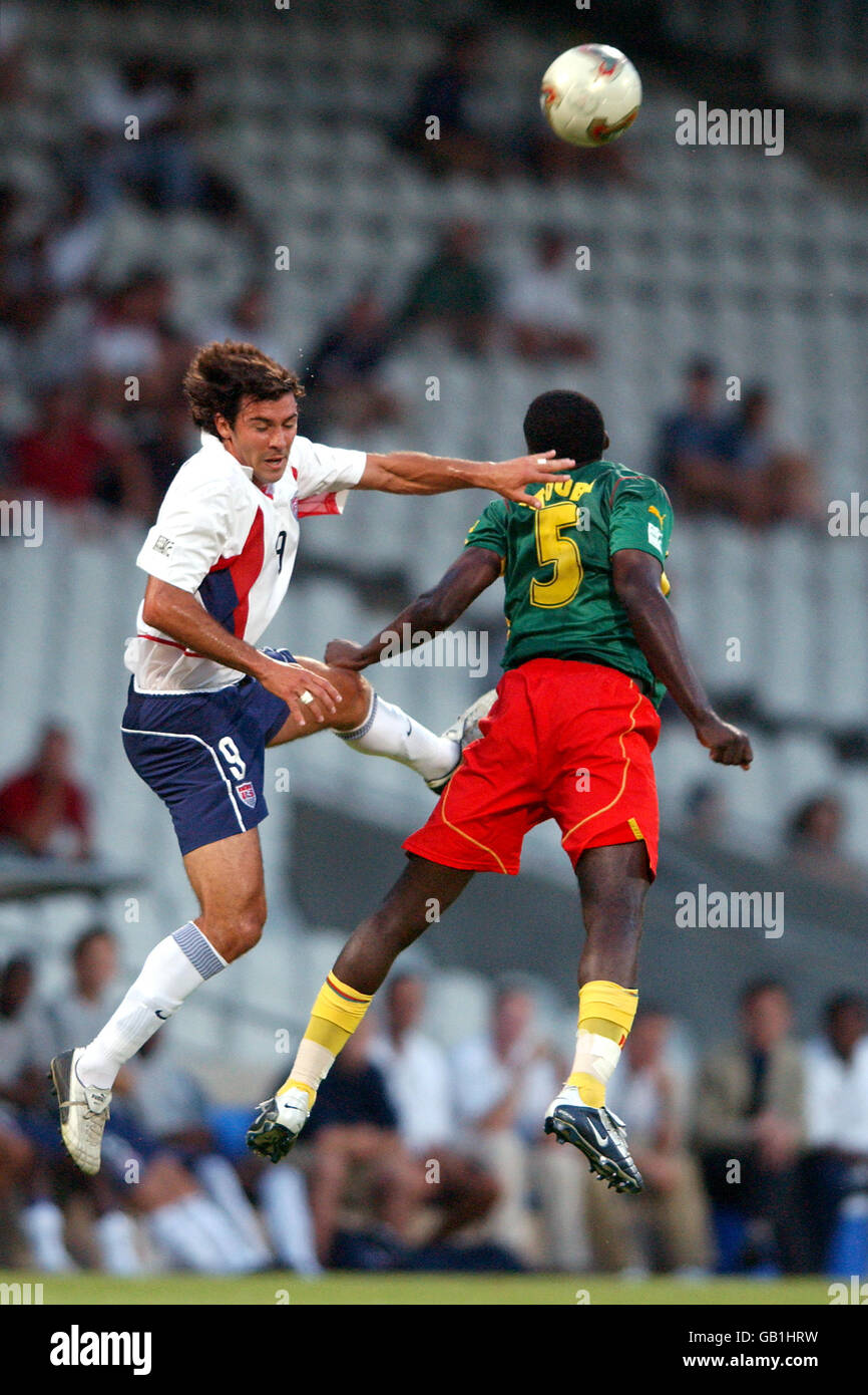 (L-R) USA's Jovan Kirovski and Cameroon's Thimothee Atouba both jump ...