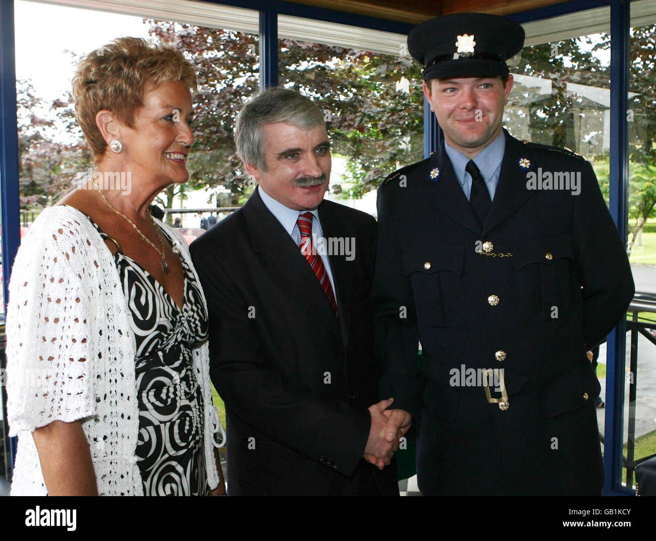 Defence Minister Willie O'Dea (centre) congratulates Garda Ross McCabe ...