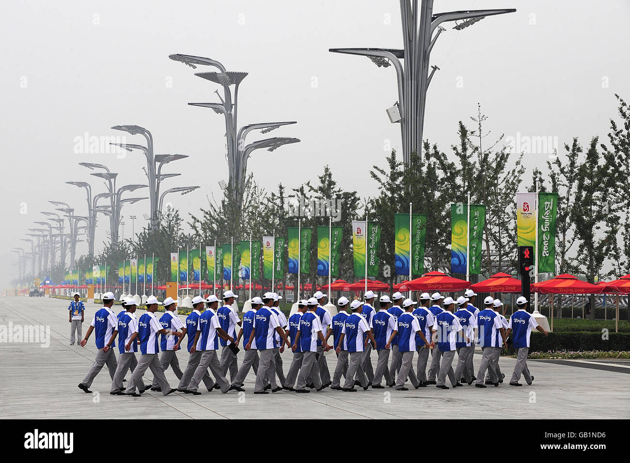 Olympic staff cross the road outside the olympic national stadium hi ...
