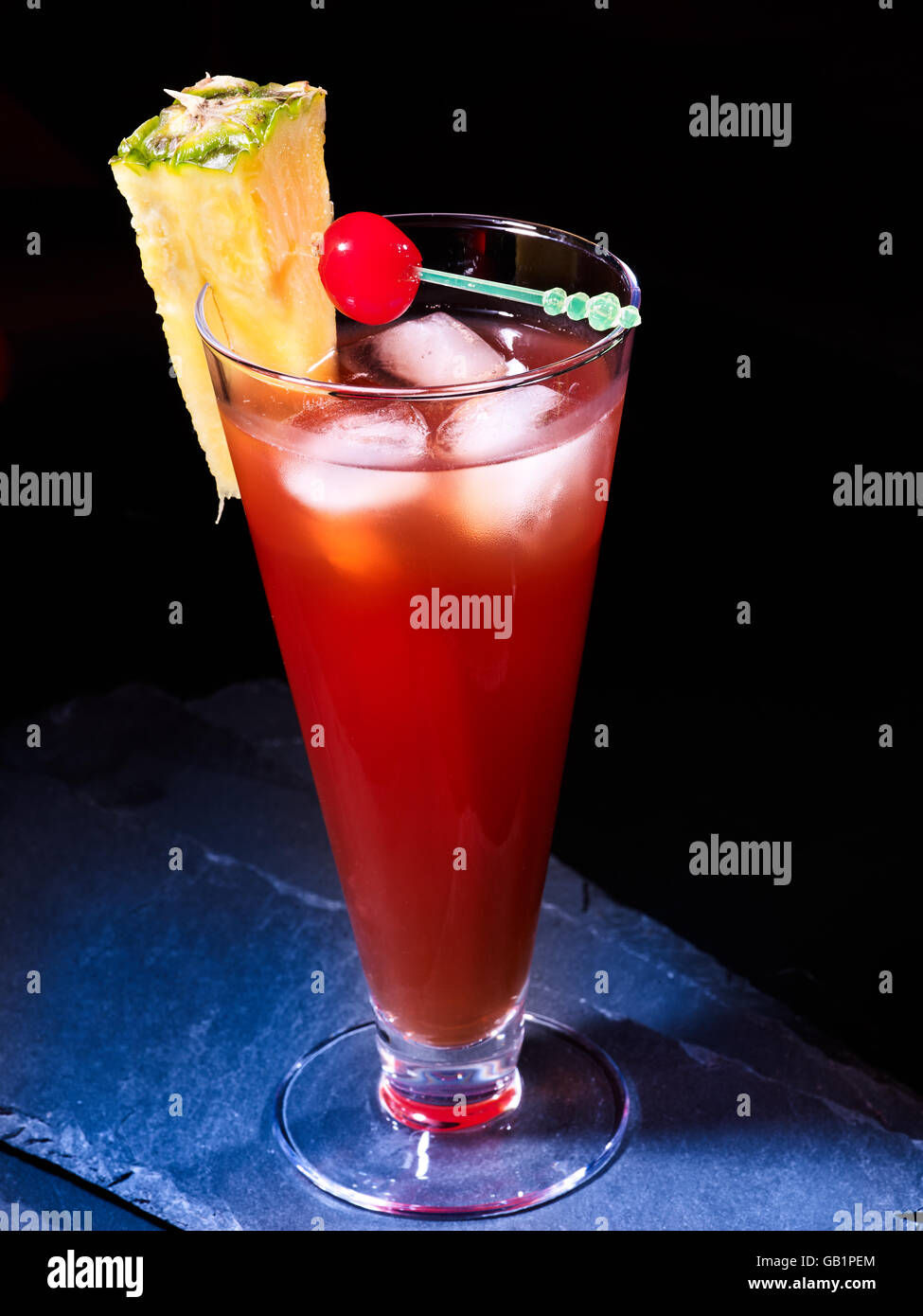 Cold red drink with ice cube in highball glass Stock Photo - Alamy