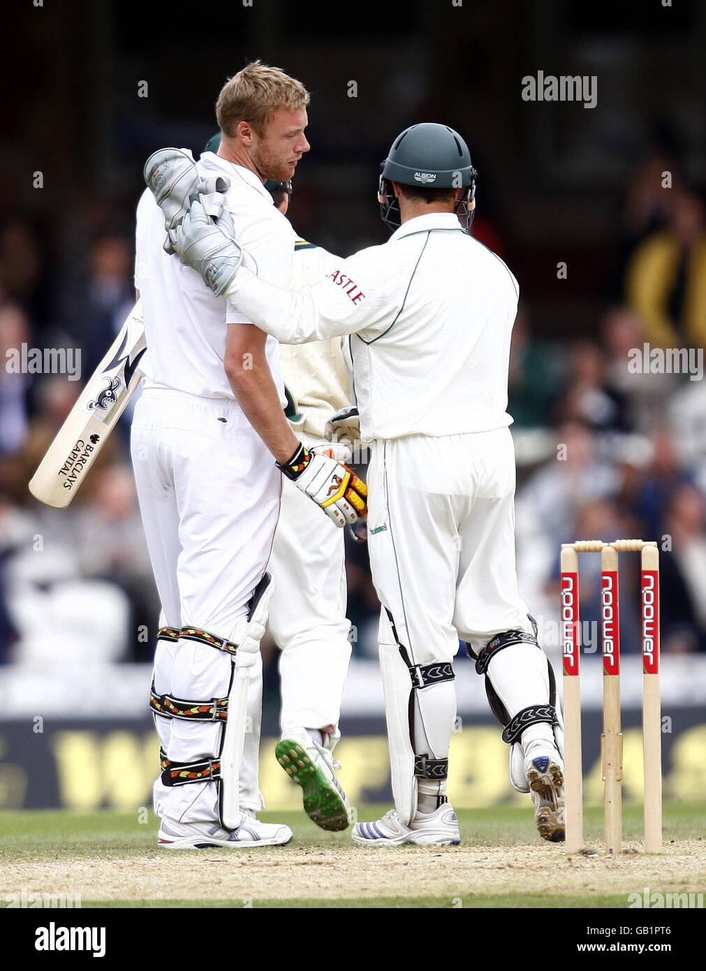 England batsman Andrew Flintoff is joined by South Africa's wicket ...
