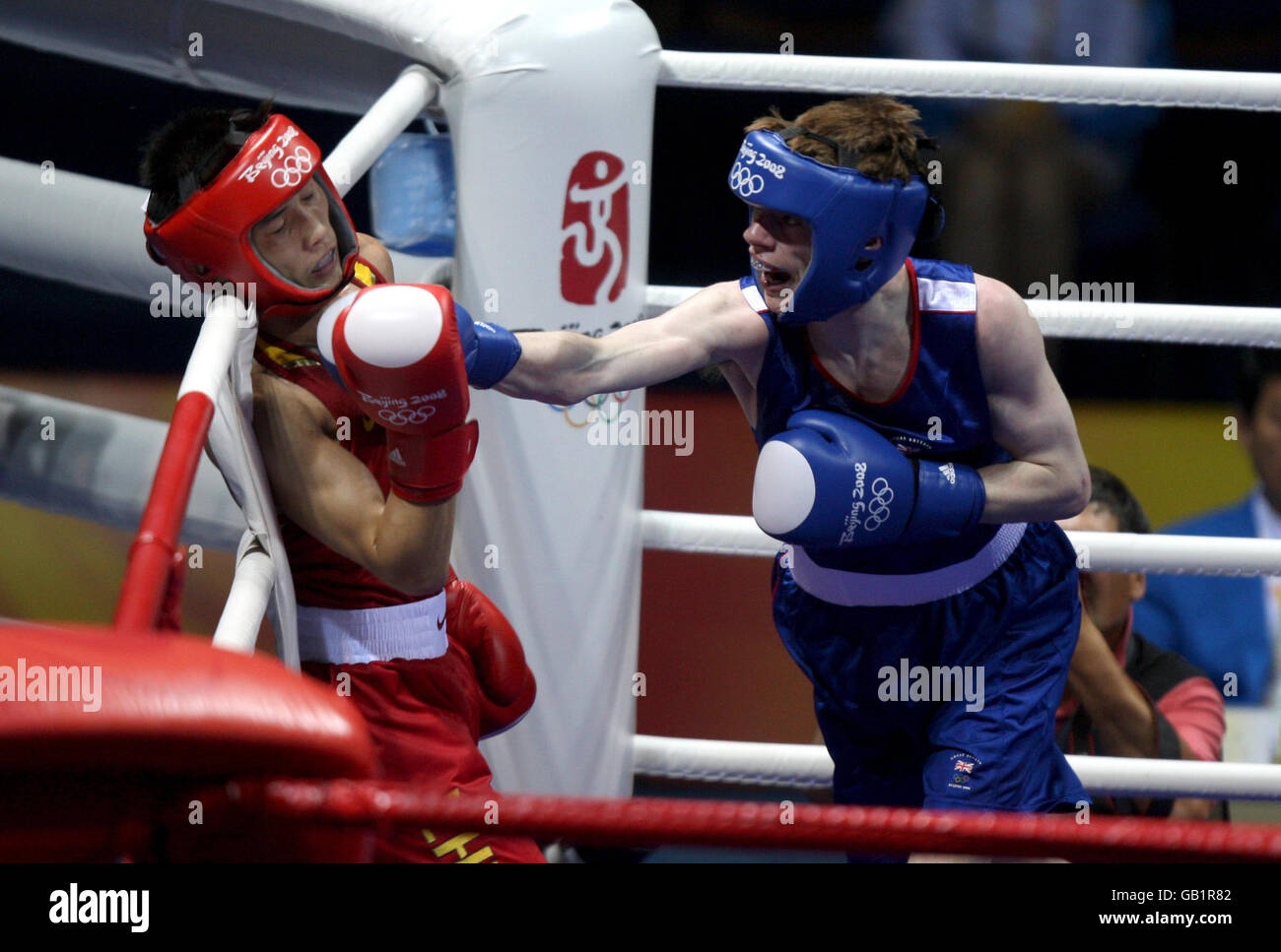 Great Britain's bantamweight boxer Joe Murray lands a punch on China's ...