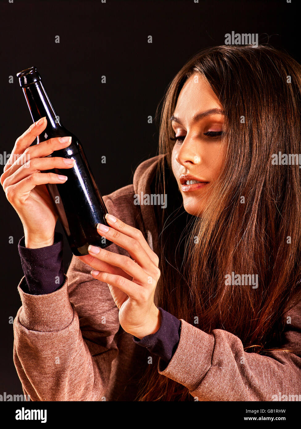 Drunk girl holding bottle of vodka Stock Photo - Alamy