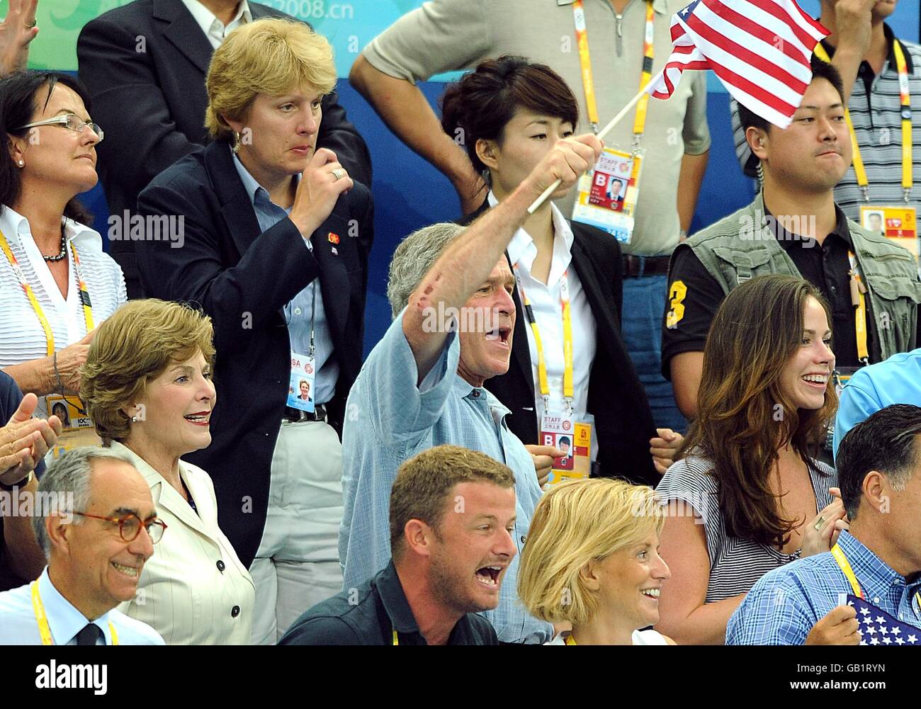 USA's President George W Bush waves an American flag as he chears on ...