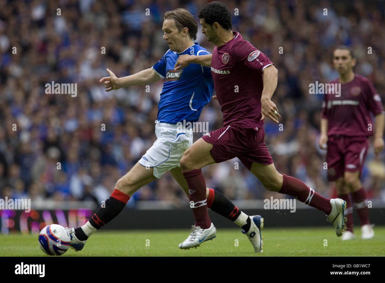 Rangers' Sasa Papac and Hearts' Christos Karipidis battle for the ball ...