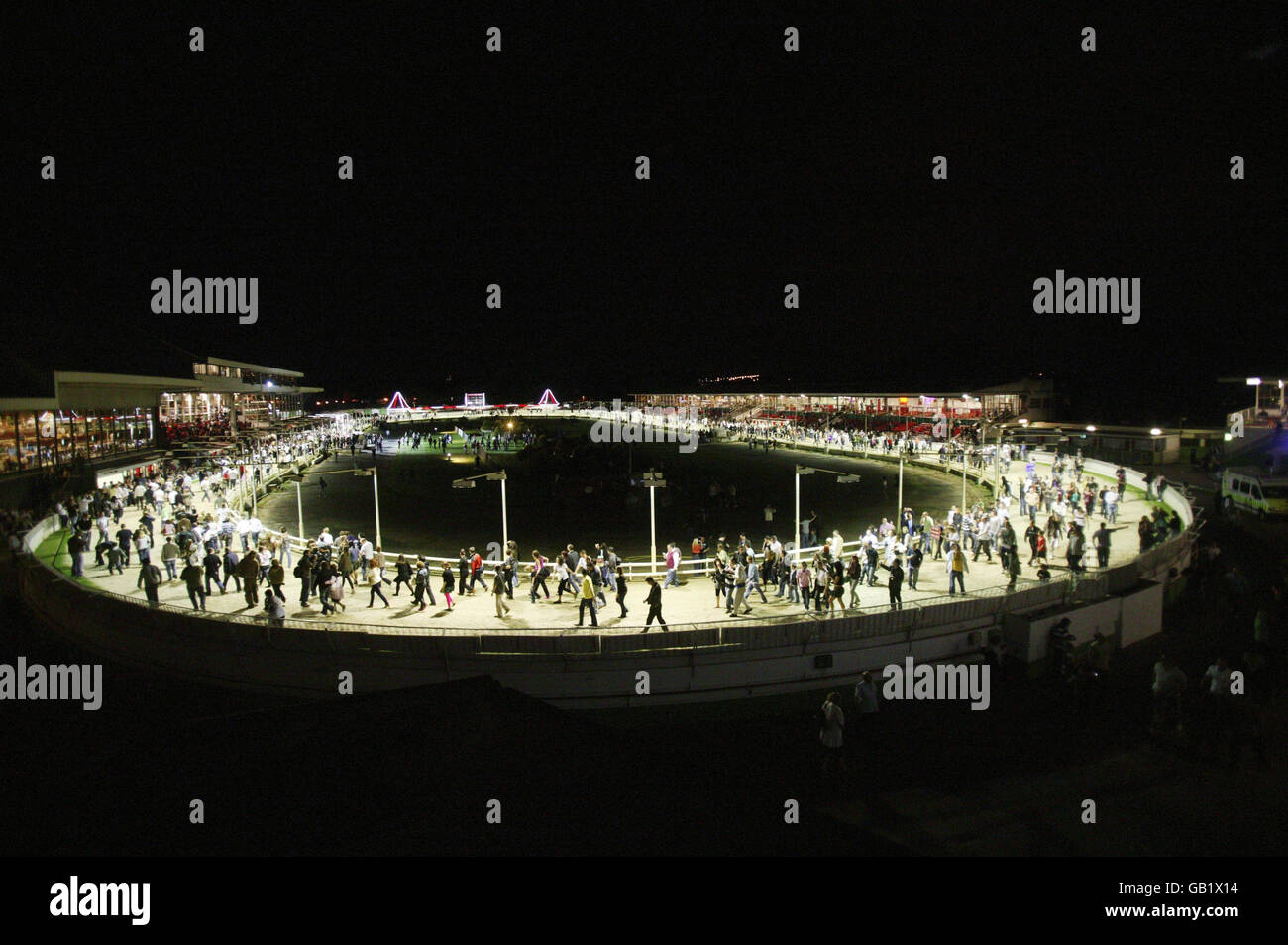 Dog track's had its day. Spectators walk on the track during the final ...
