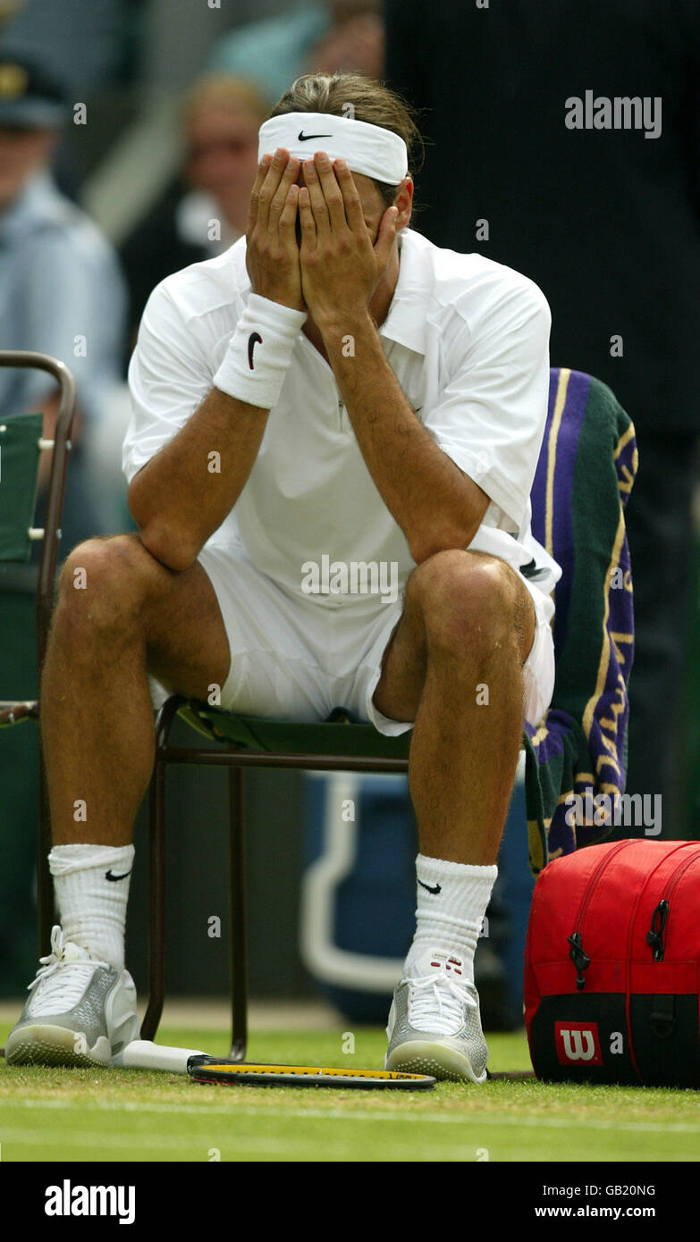 Roger Federer bursts into tears as he sits in his chair after winning ...
