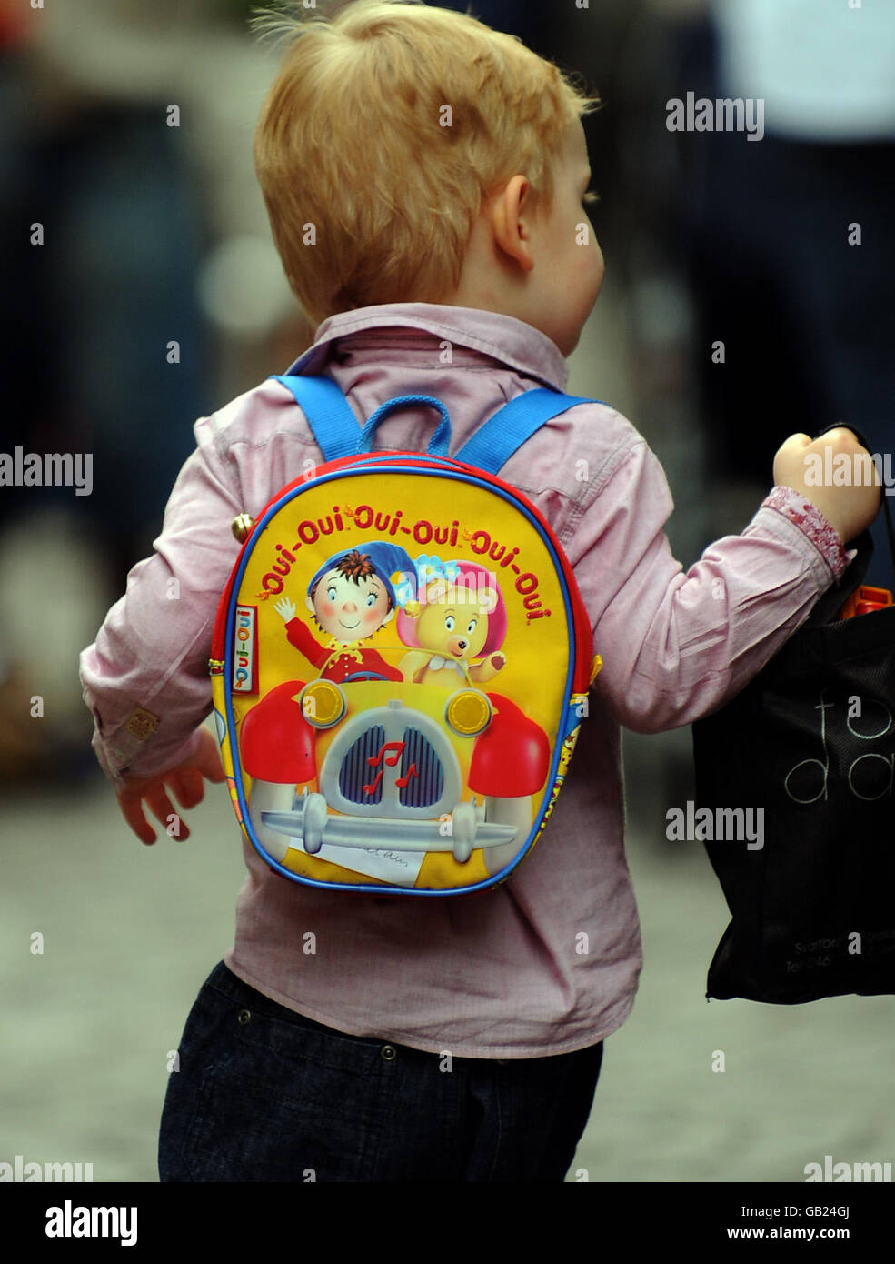 A young boy wears a French themed Noddy backpack in Geneva, Switzerland ...