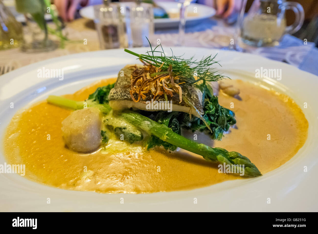 Skrei cod with dill, spinach, asparagus and lobster sauce Stock Photo ...