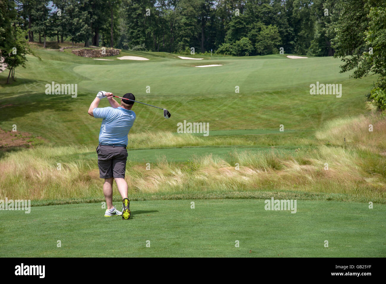 View From Behind Golfer As He Swings Off Golf Tee Stock Photo - Alamy