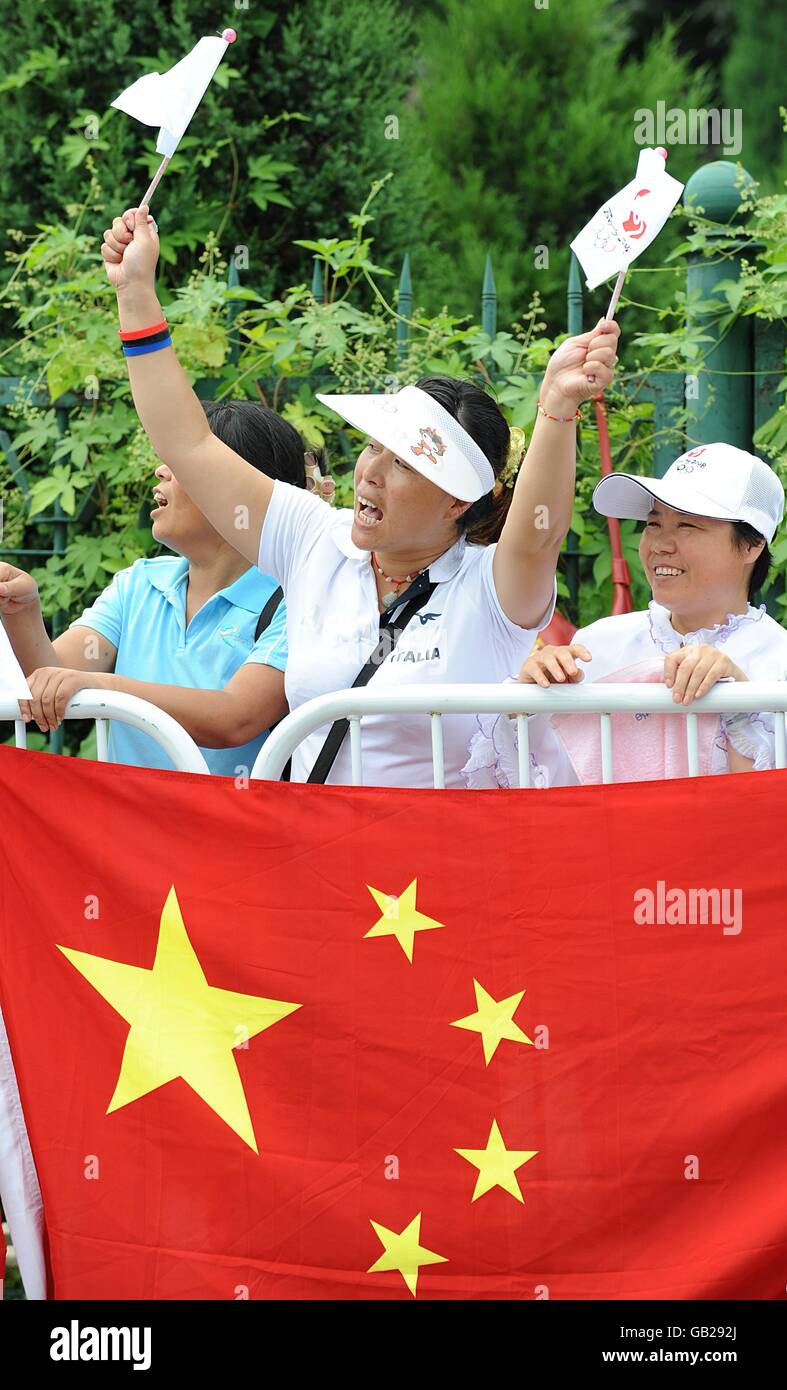 A Chinese fan waves flags whilst watching the Women's Individual Time ...