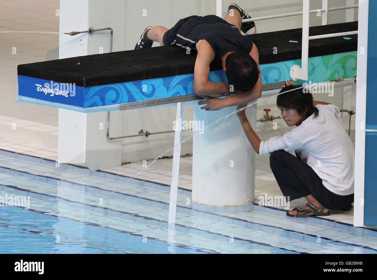 Workmen put logos on dive national aquatic centre in beijing hi-res ...