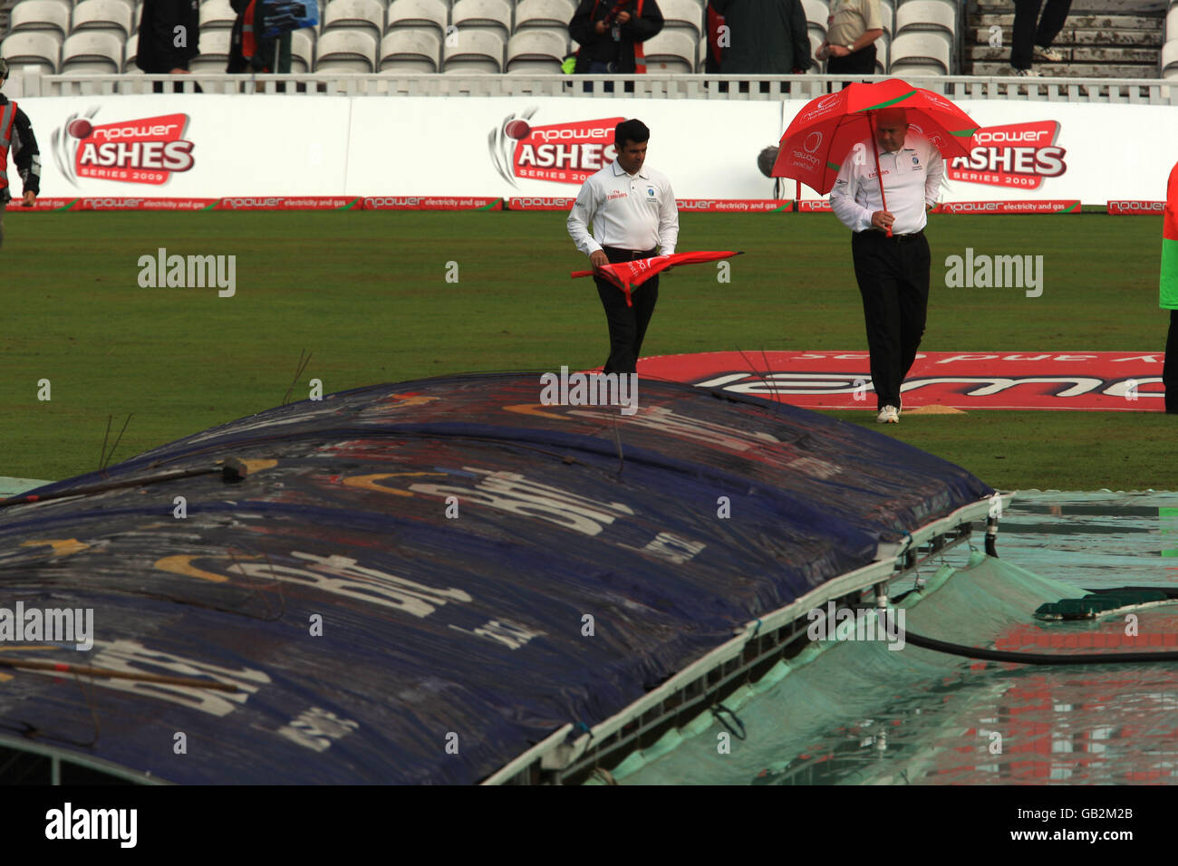 Match umpires Steve Davis and Aleem Dar inspect the ground before ...