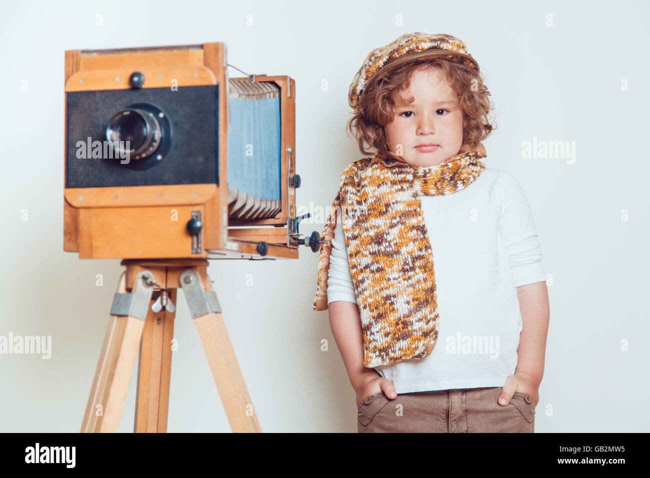 Little boy standing near the camera on a white background Stock Photo ...