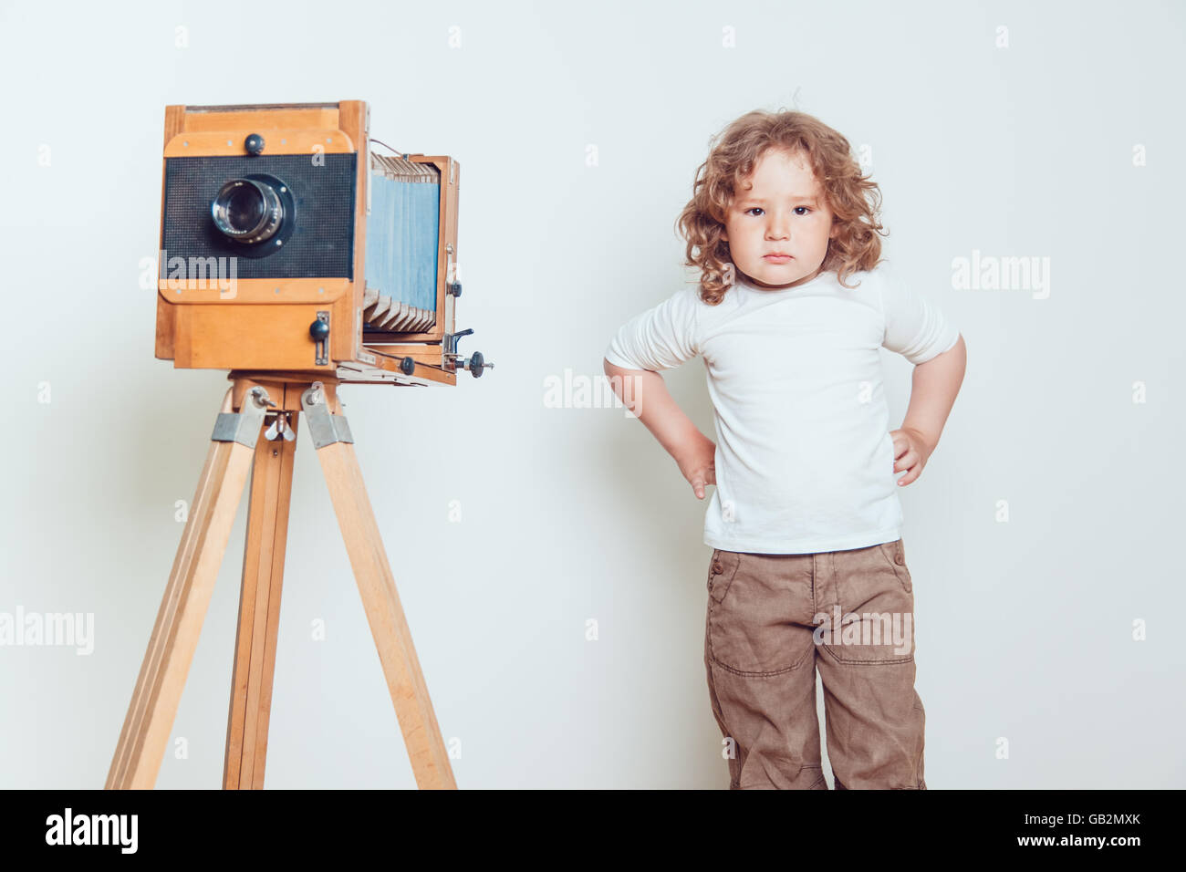 Little boy standing near the camera on a white background Stock Photo ...