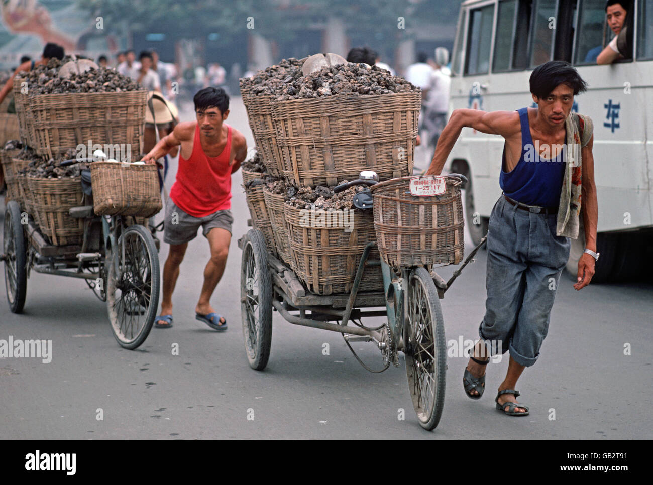 Bicycle carriers pushing heavy loads in Chengdu, Sichuan Province ...