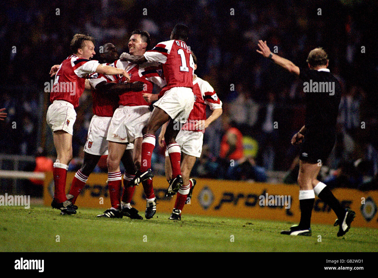 Arsenal's Andy Linighan (c) is mobbed by teammates after scoring the ...