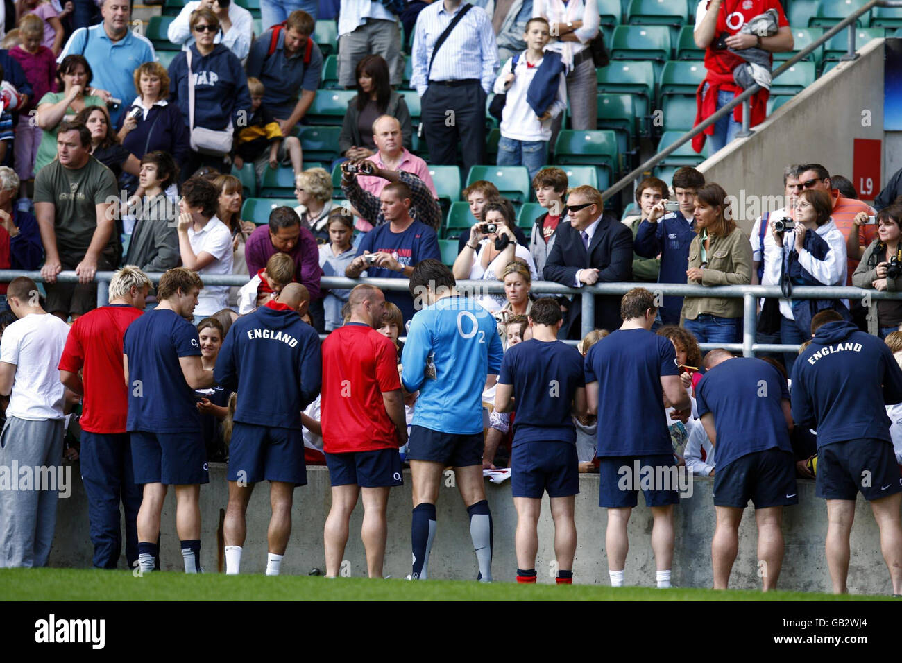 England players sign autographs for the fans at a open training session ...