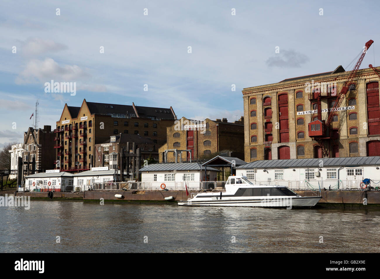 Boats docked by wharves in London, England. The vessels are seen from ...
