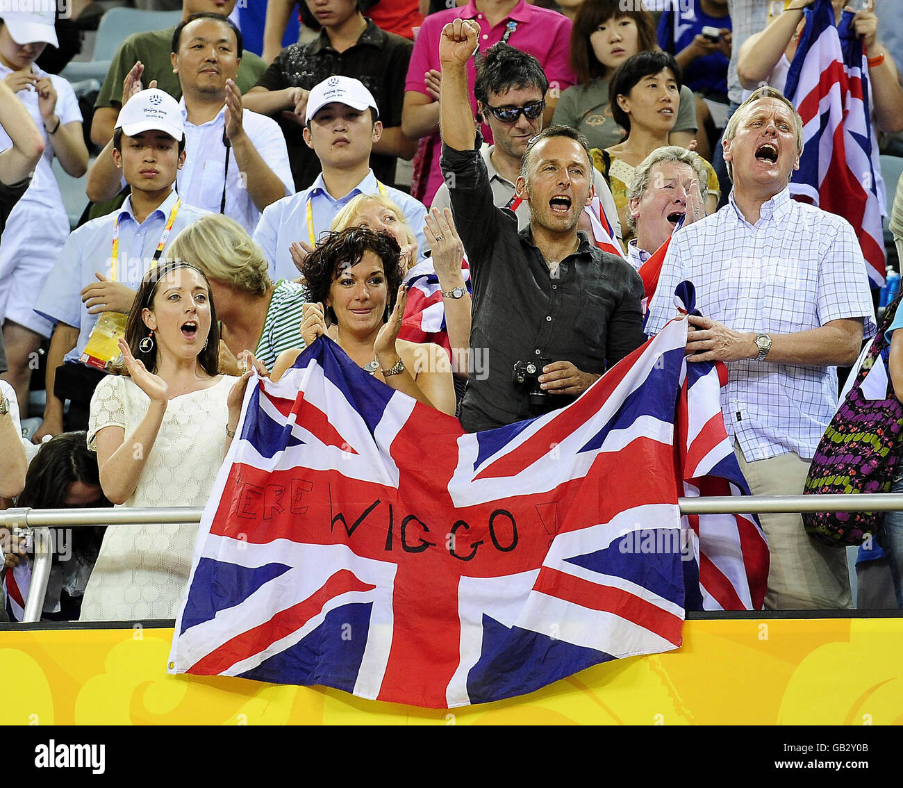 Cath Wiggins (second left) watches husband Bradley win the Gold Medal ...