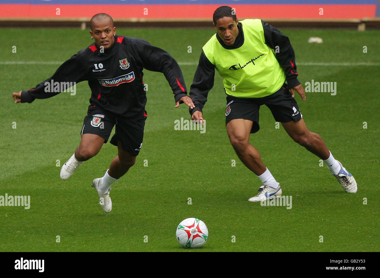 Wales' Robert Earnshaw is challenged for the ball by Andrew Williams ...